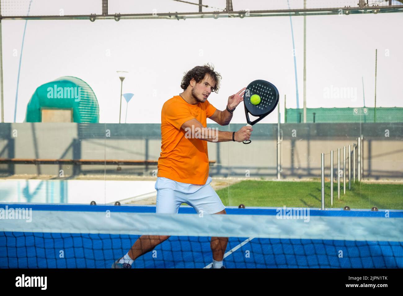 Padel match in a blue grass padel court - Padel player playing a match ...
