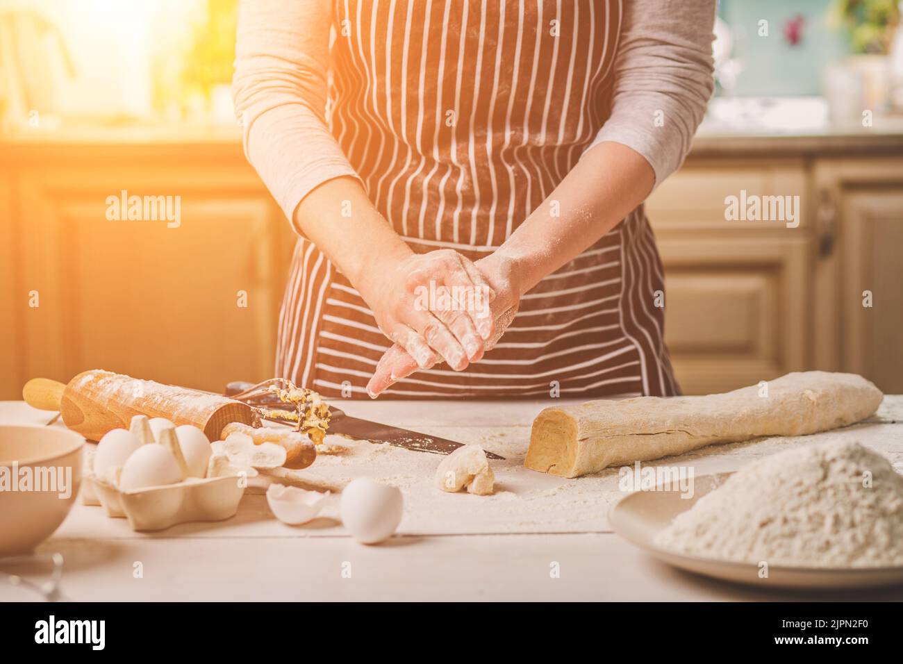 Woman bake pies. Confectioner makes desserts. Making buns. Dough on the ...