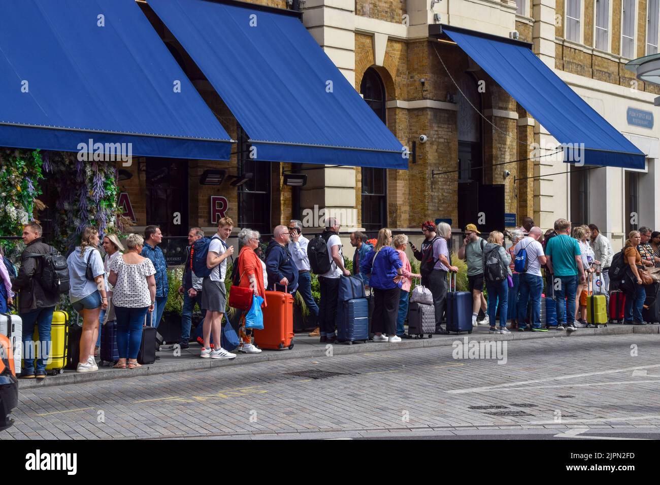 London, UK. 19th August 2022. A huge queue forms at a taxi rank outside ...