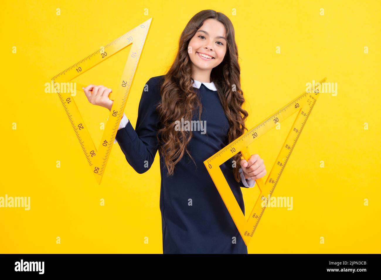 Schoolgirl in school uniform hold mathematics measure. Metric ...