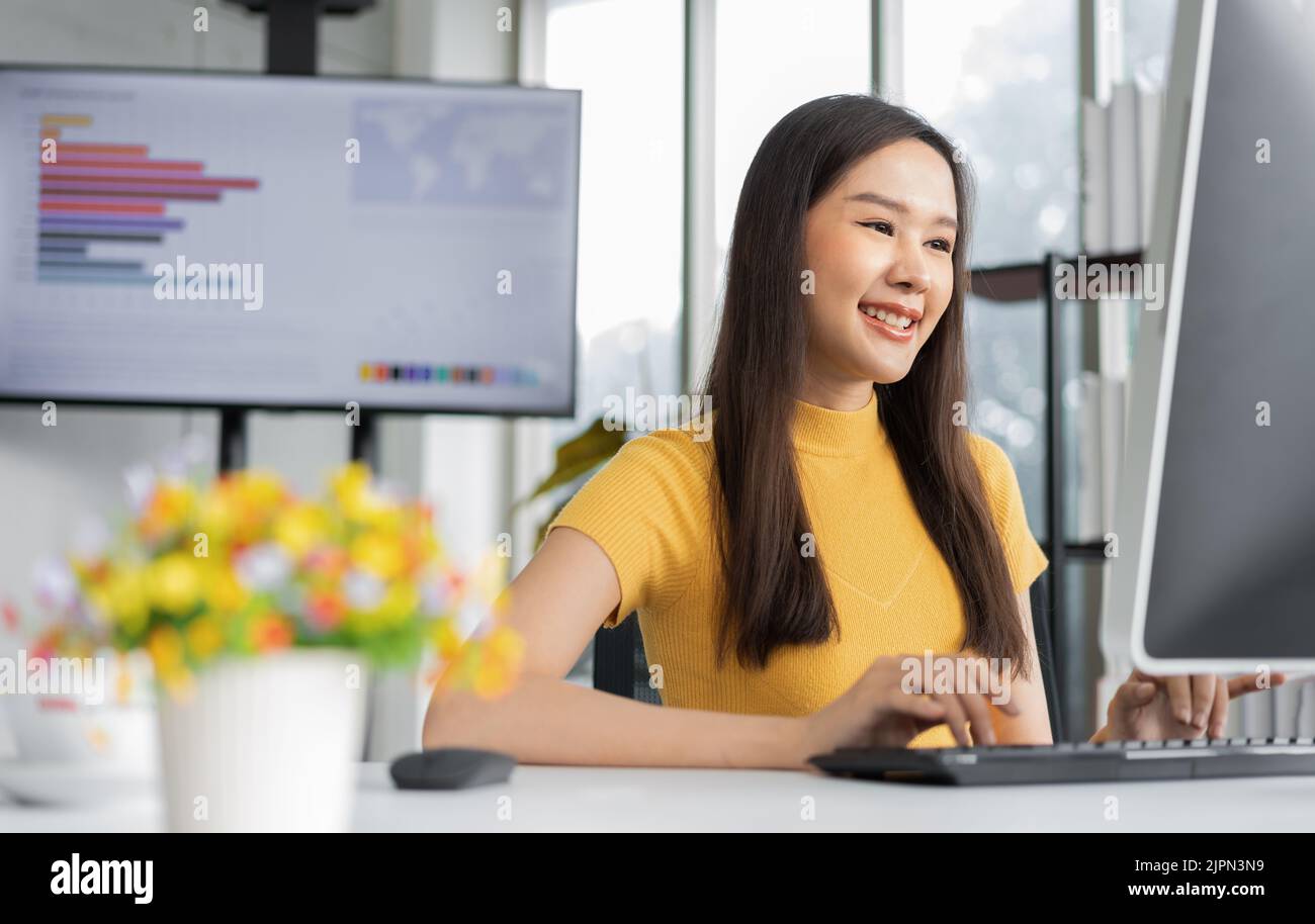 Portrait happy young programmer Asian woman work at start up technology ...