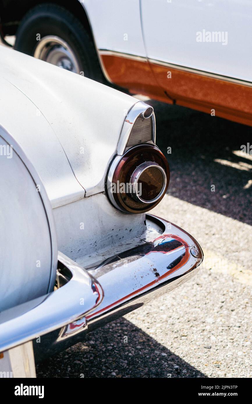 A vertical rear view of the tail light of white retro car Stock Photo ...