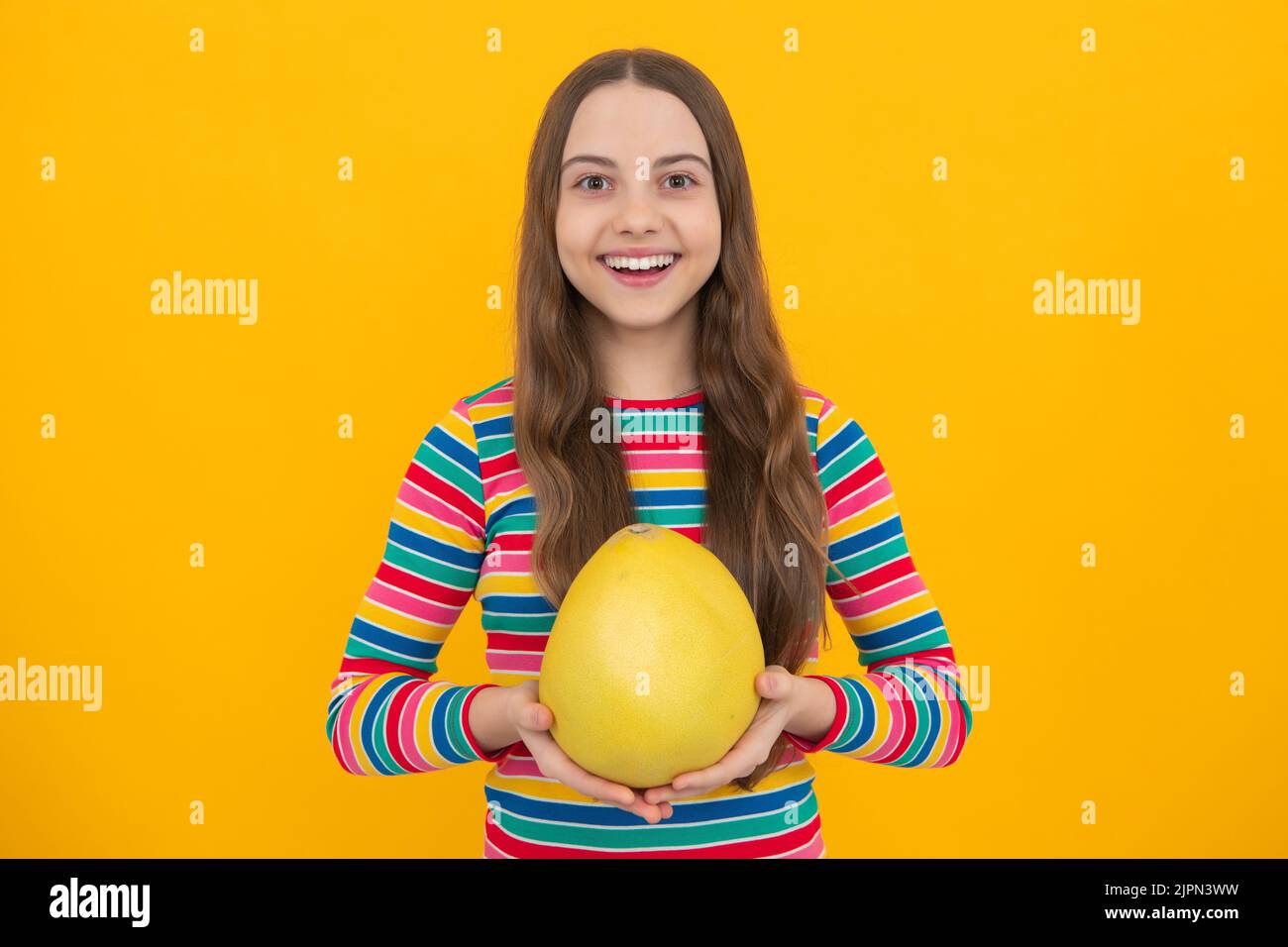 Teenager child girl hold citrus fruit pummelo or pomelo full of vitamin ...