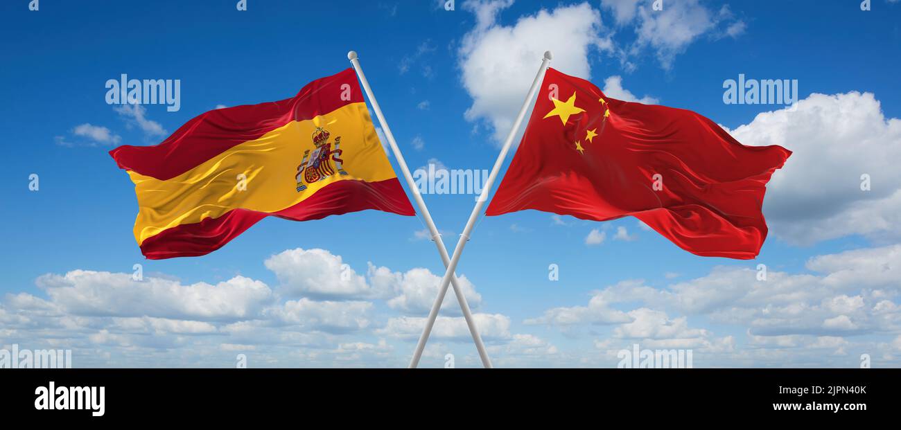 two crossed flags china and spain waving in wind at cloudy sky. Concept ...