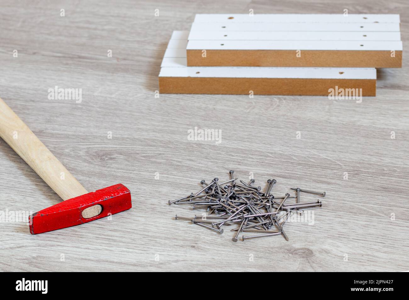 Construction tools on the ground; Hammer, nails and chipboard Stock ...