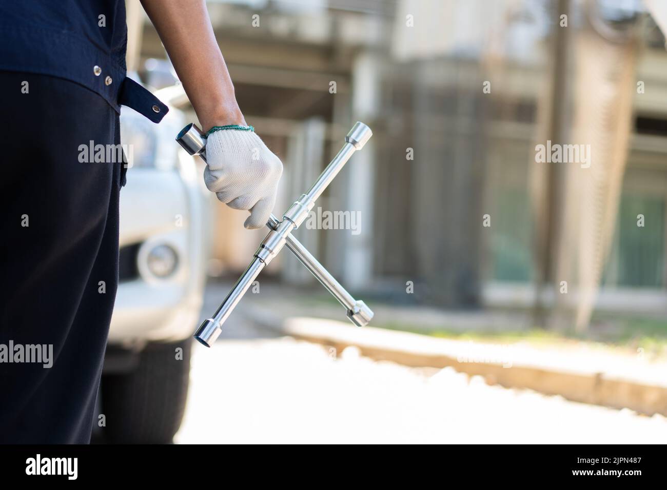 Focus car mechanic hand holding wrench for change the wheel on a broken ...