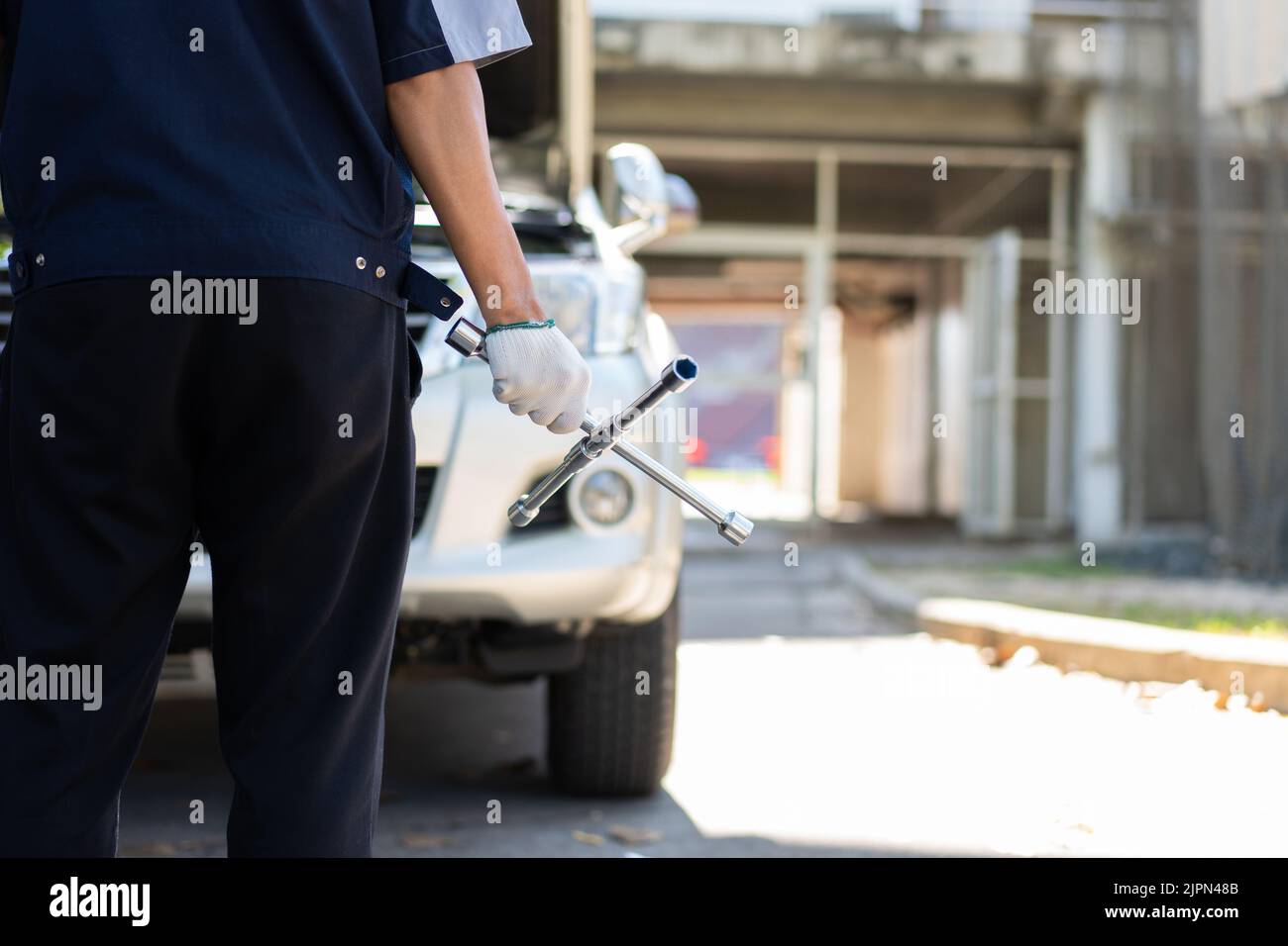 Focus car mechanic hand holding wrench for change the wheel on a broken ...
