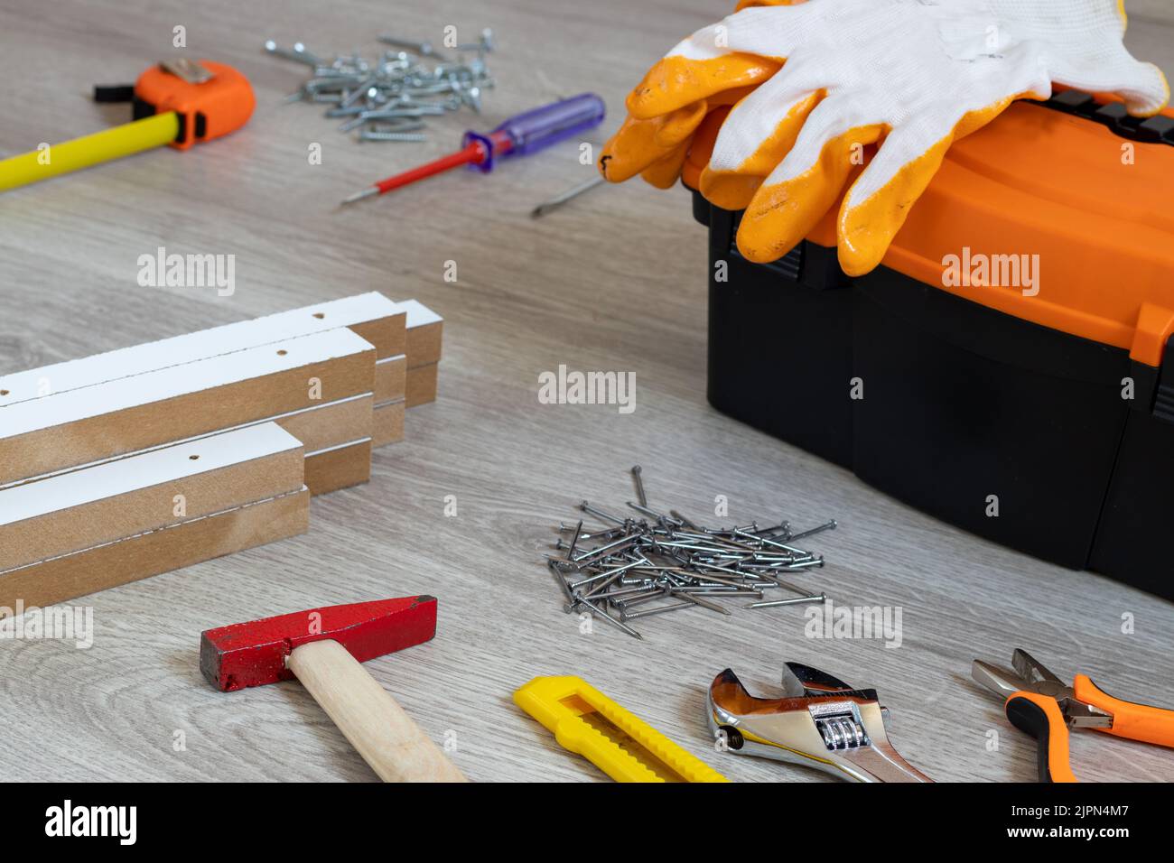 Toolbox with Various Work Tools on Wooden Floor Stock Photo - Alamy