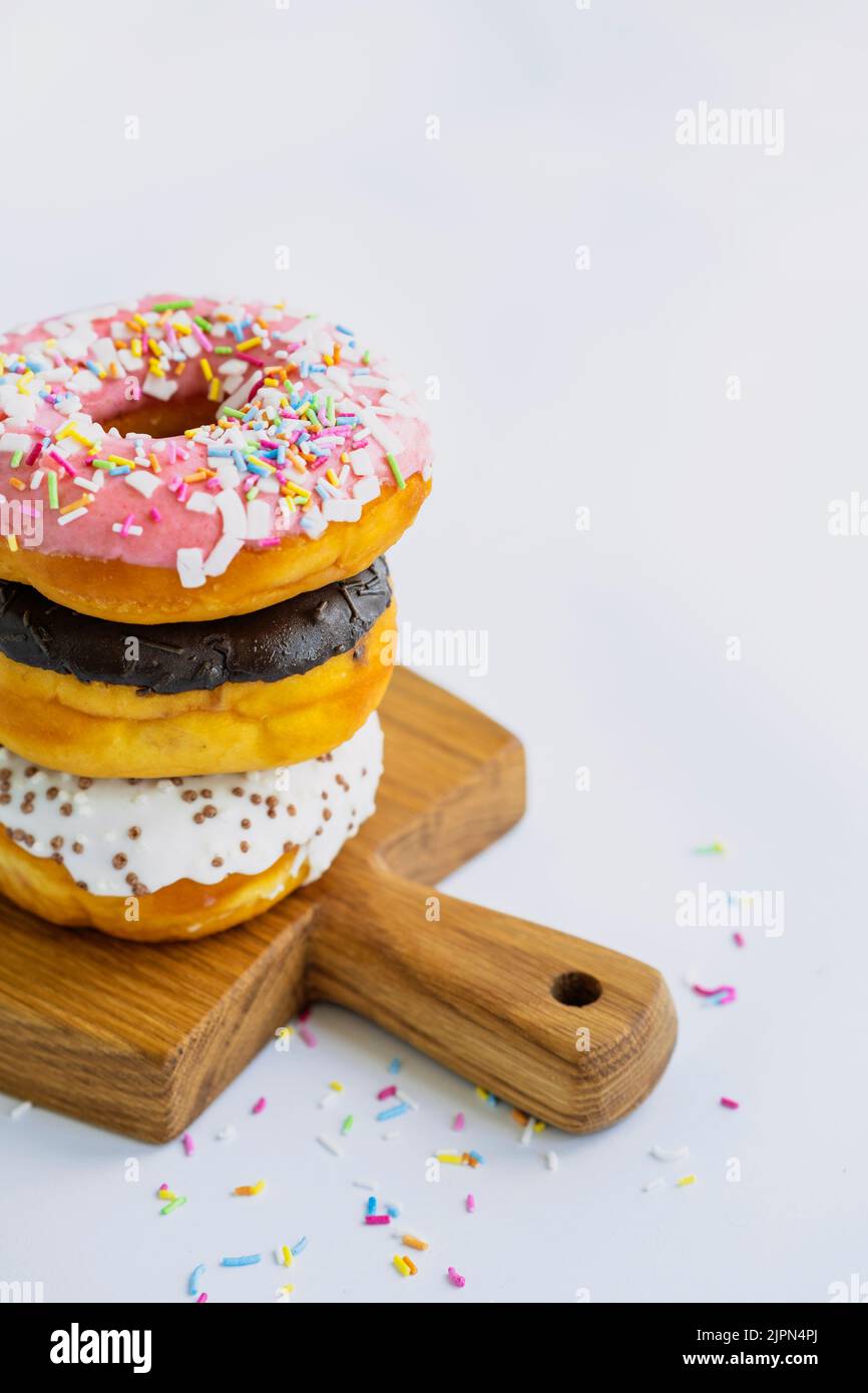 Delicious donuts on wooden board, placed on wooden cutting board on ...