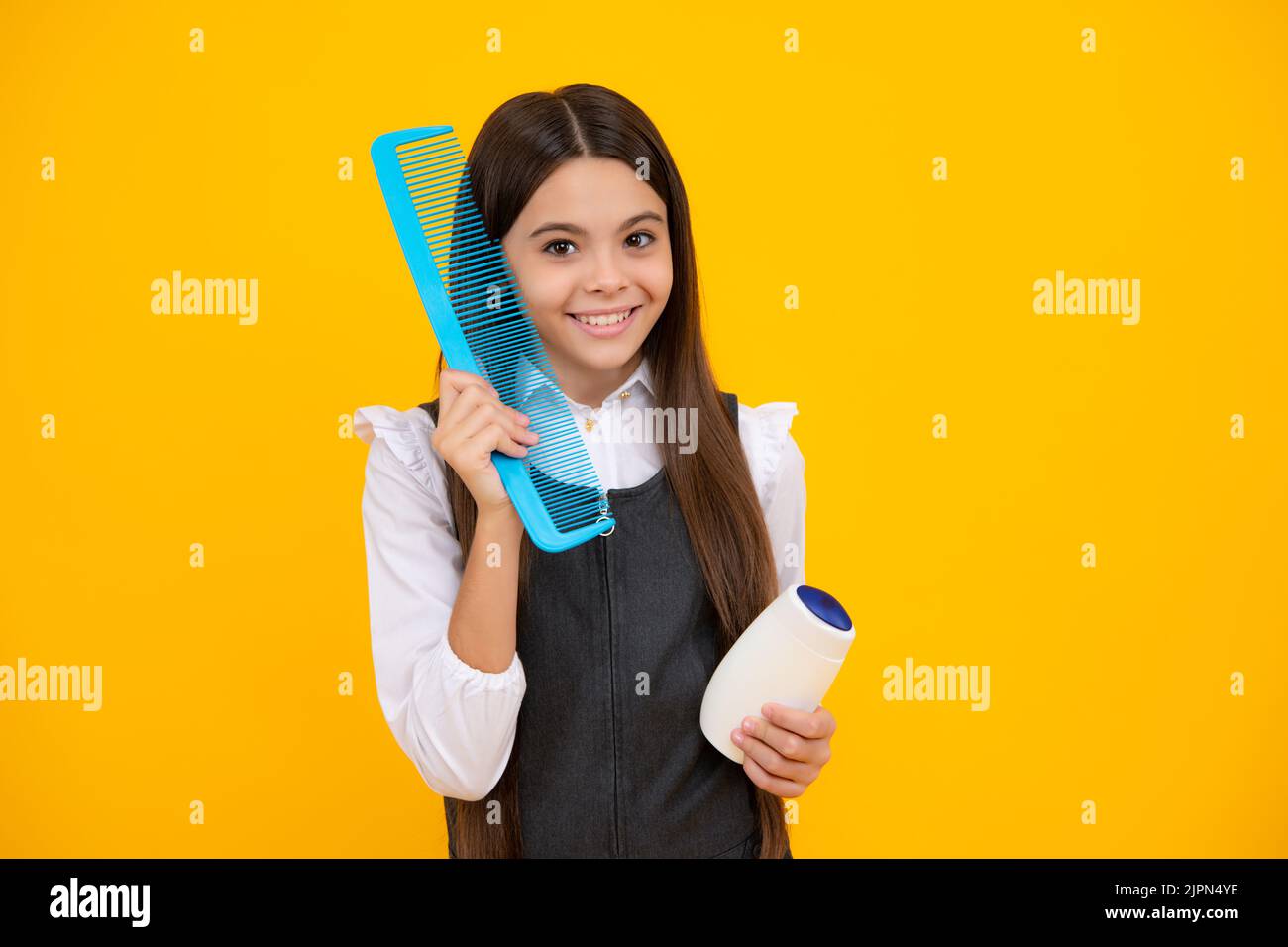 Child teen girl with shampoos conditioners and shower gel. Long hair ...