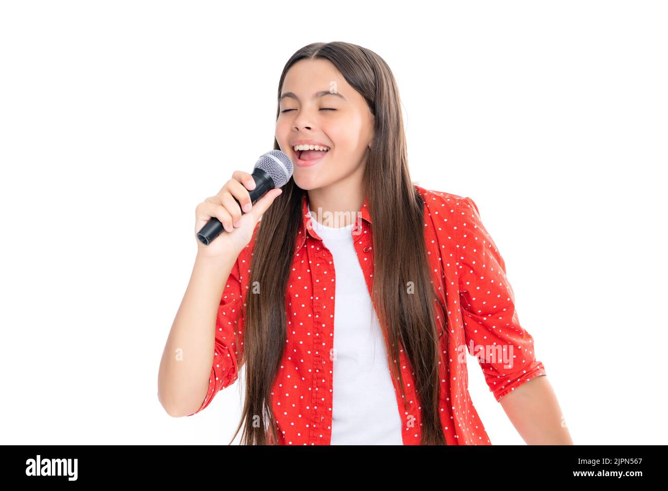 Child girl holding wireless microphone for karaoke singing or talk and ...