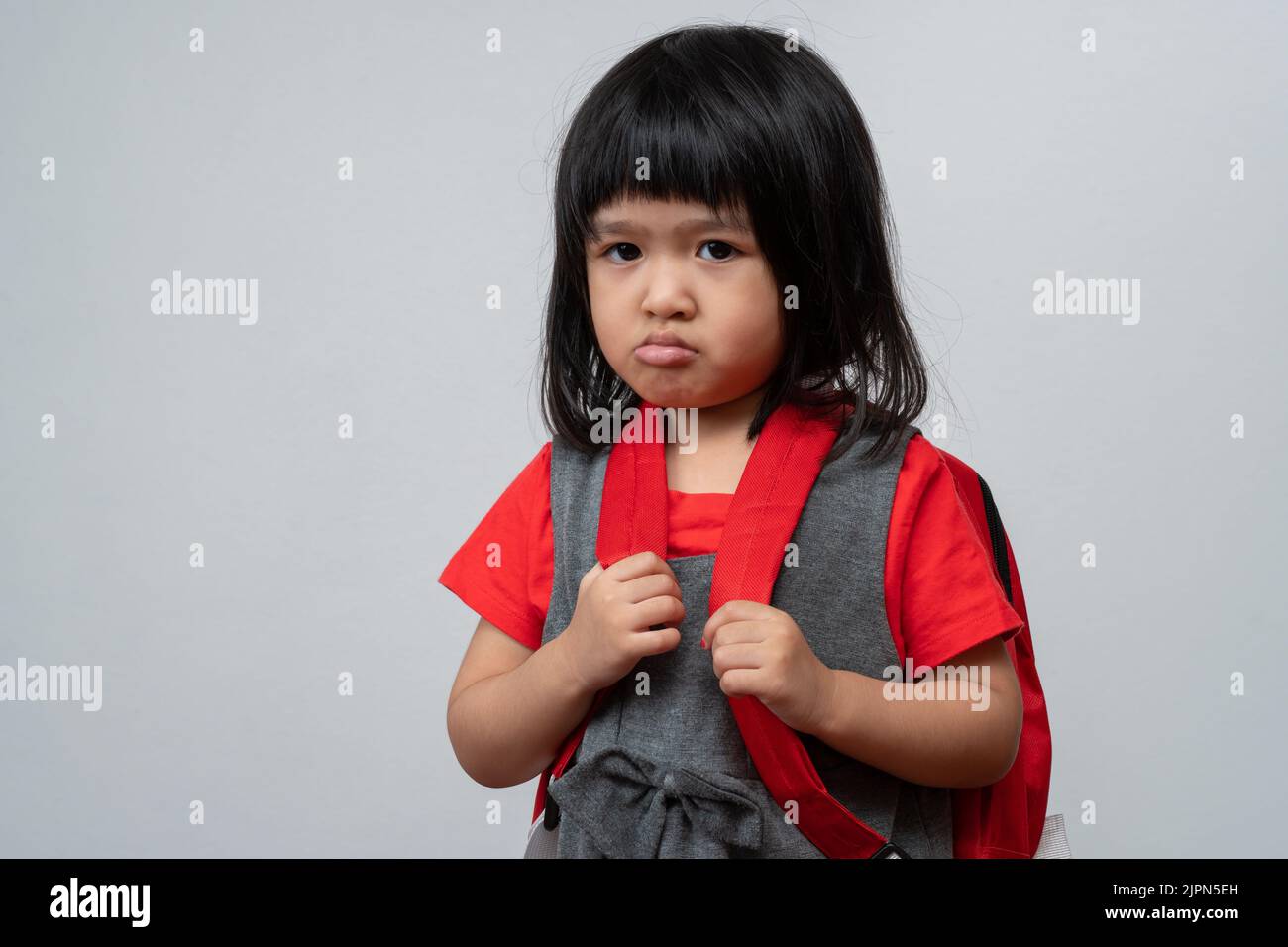 Portrait of Asian angry and sad little girl on white isolated ...