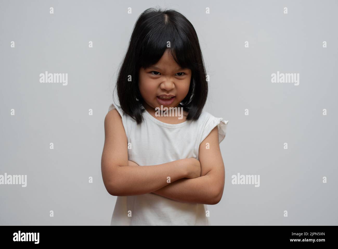 Portrait of Asian angry and sad little girl on white isolated ...