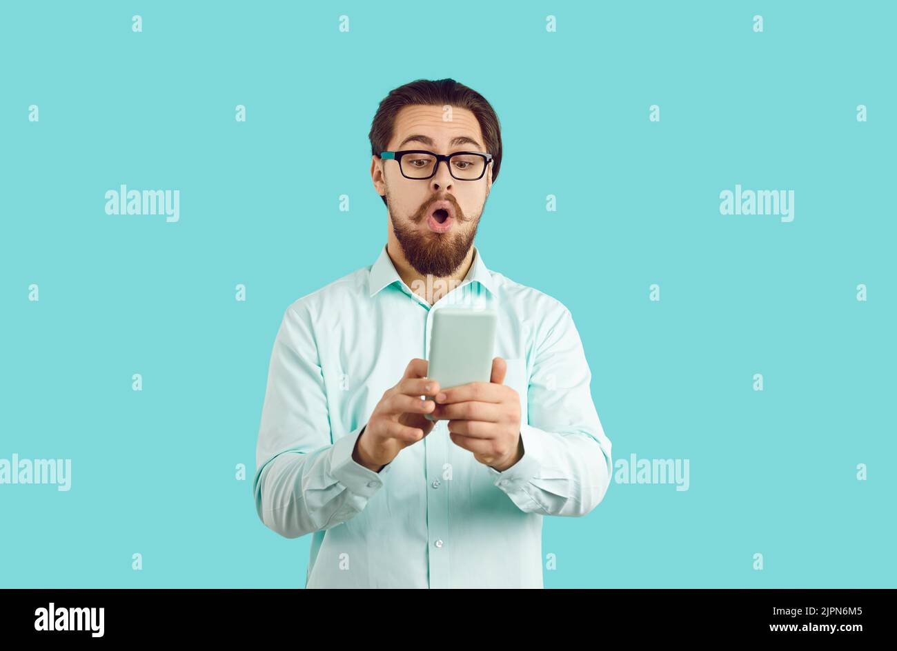 Man gets notification and looks at his mobile phone with happy ...