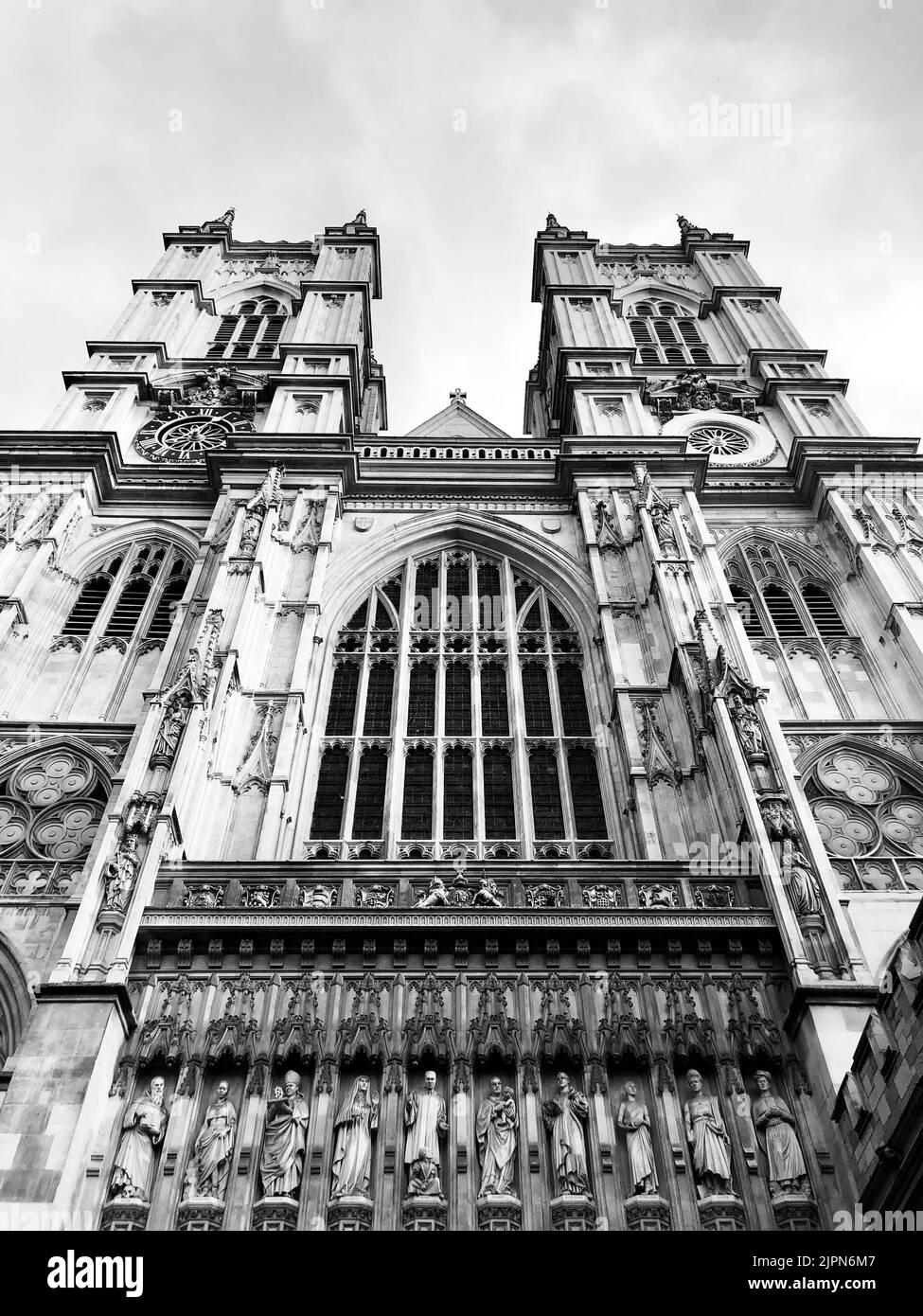 A vertical low angle of the famous Westminster Abbey in UK in greyscale ...