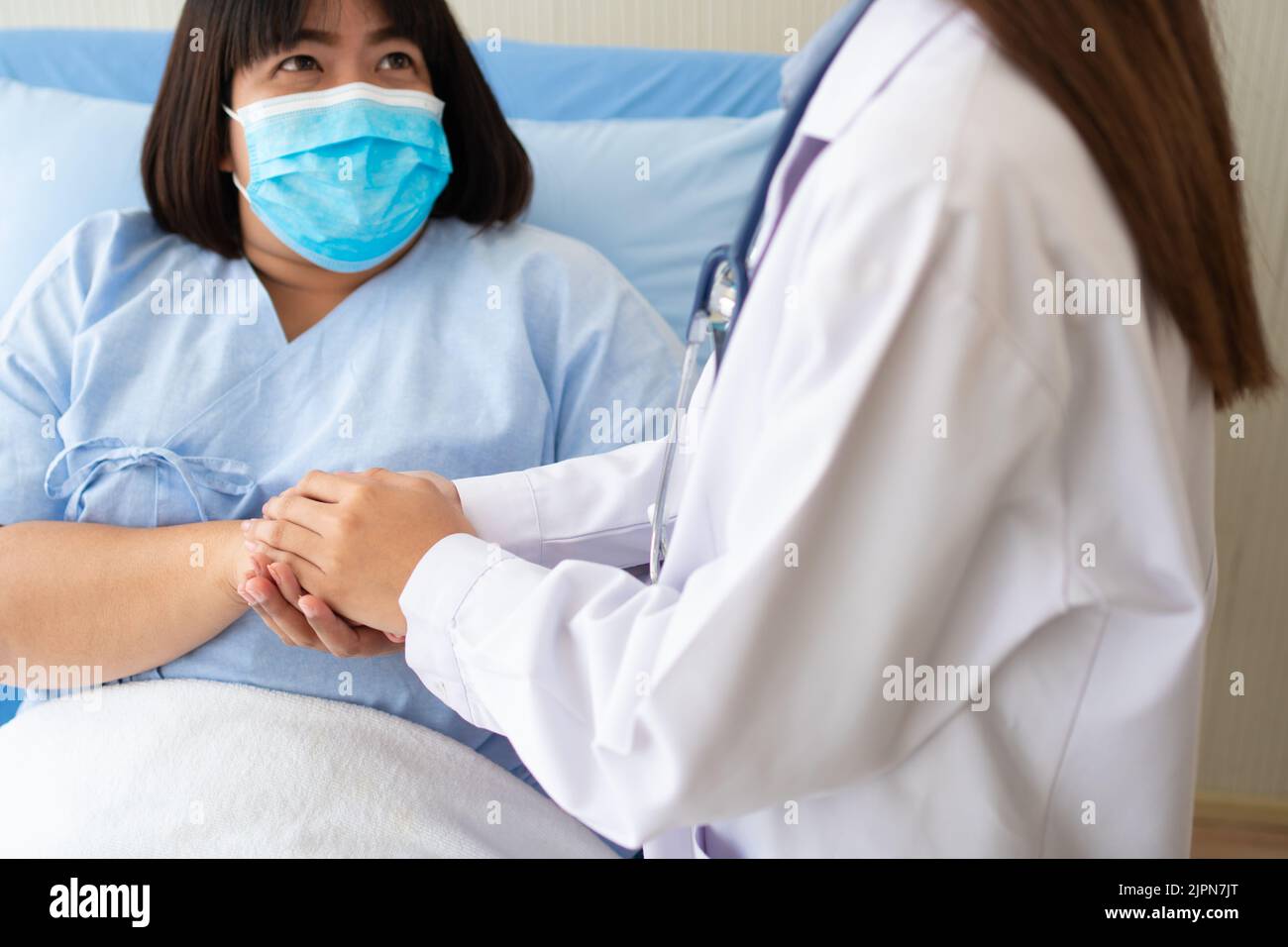 Women Asian doctors hold the patient hand and encourage and provide ...