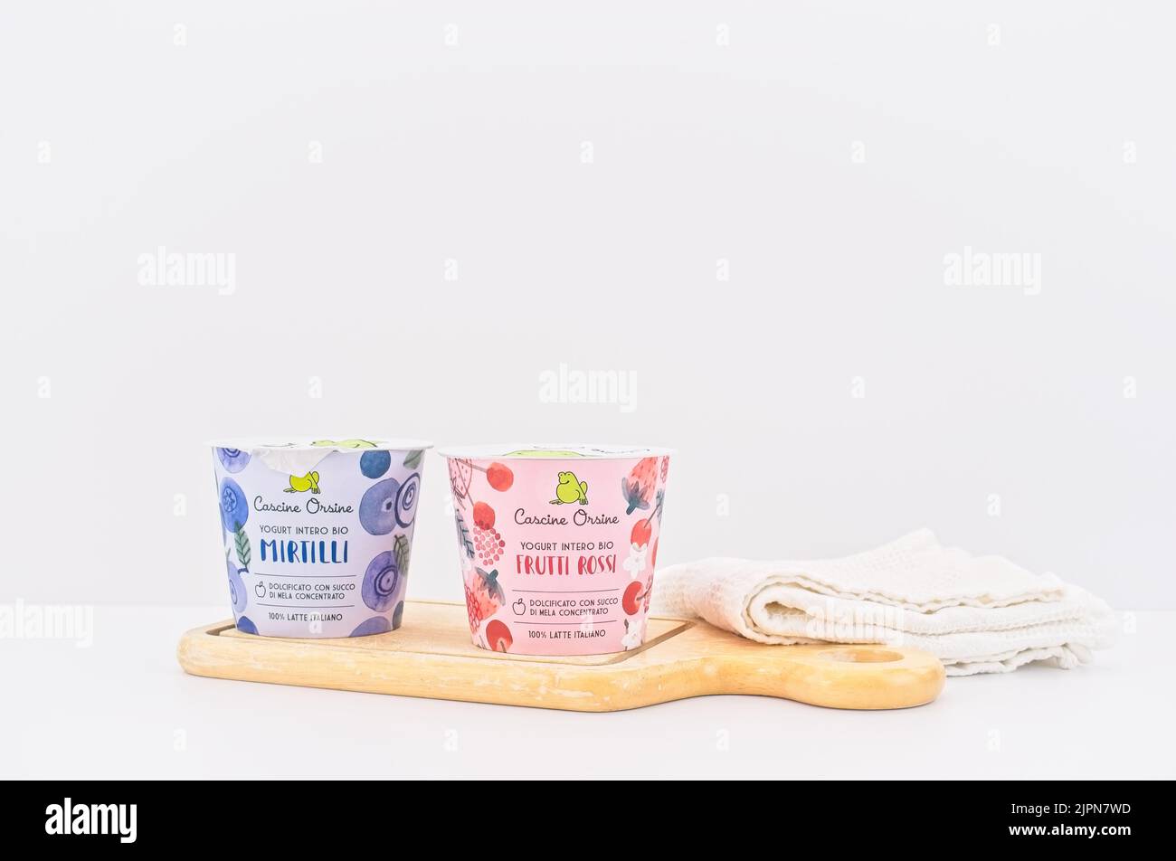 fruits organic farming yogurt jar with kitchenware on a white table ...