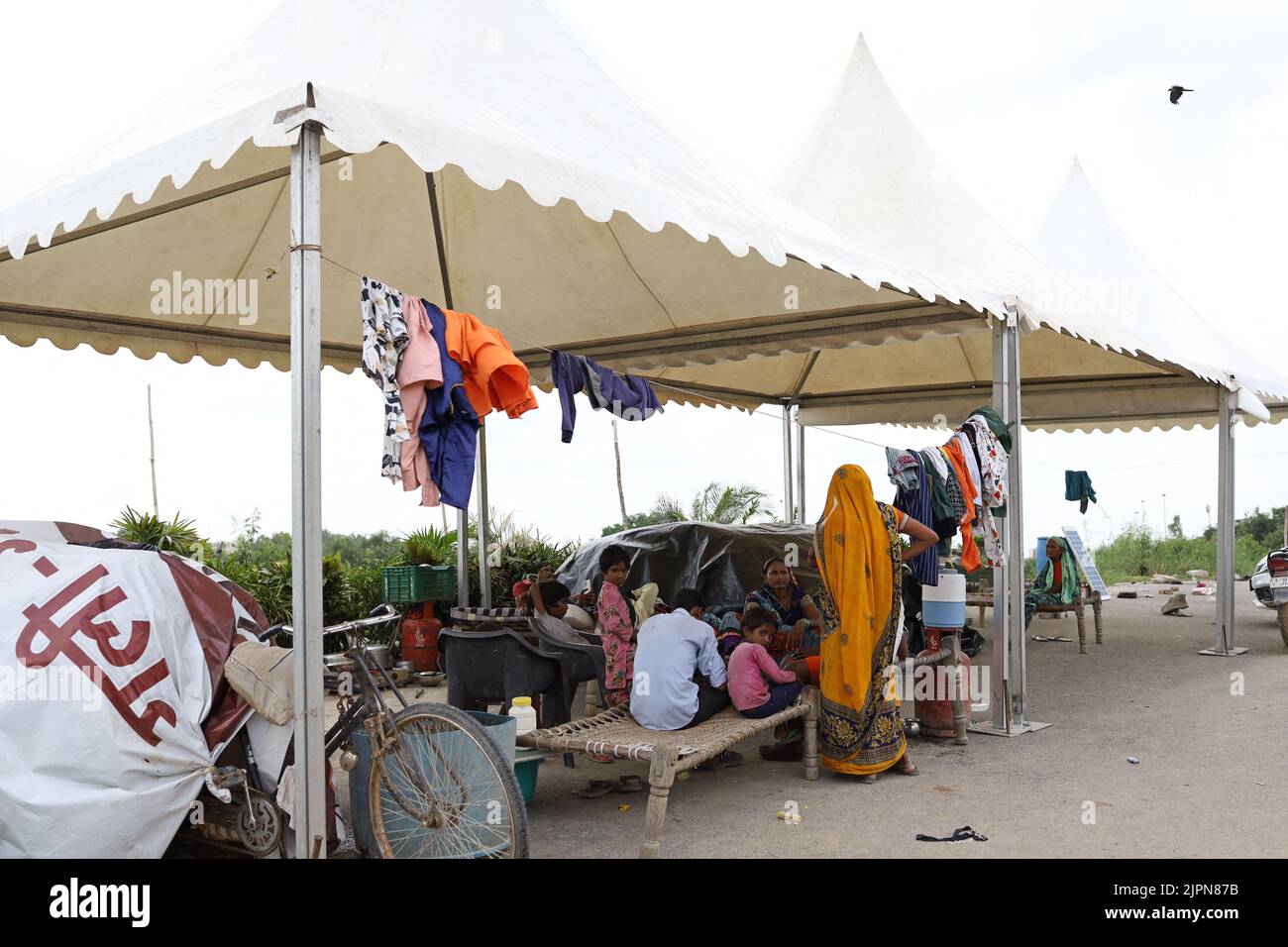 Flood affected people seen taking shelter in make shift setup provided ...