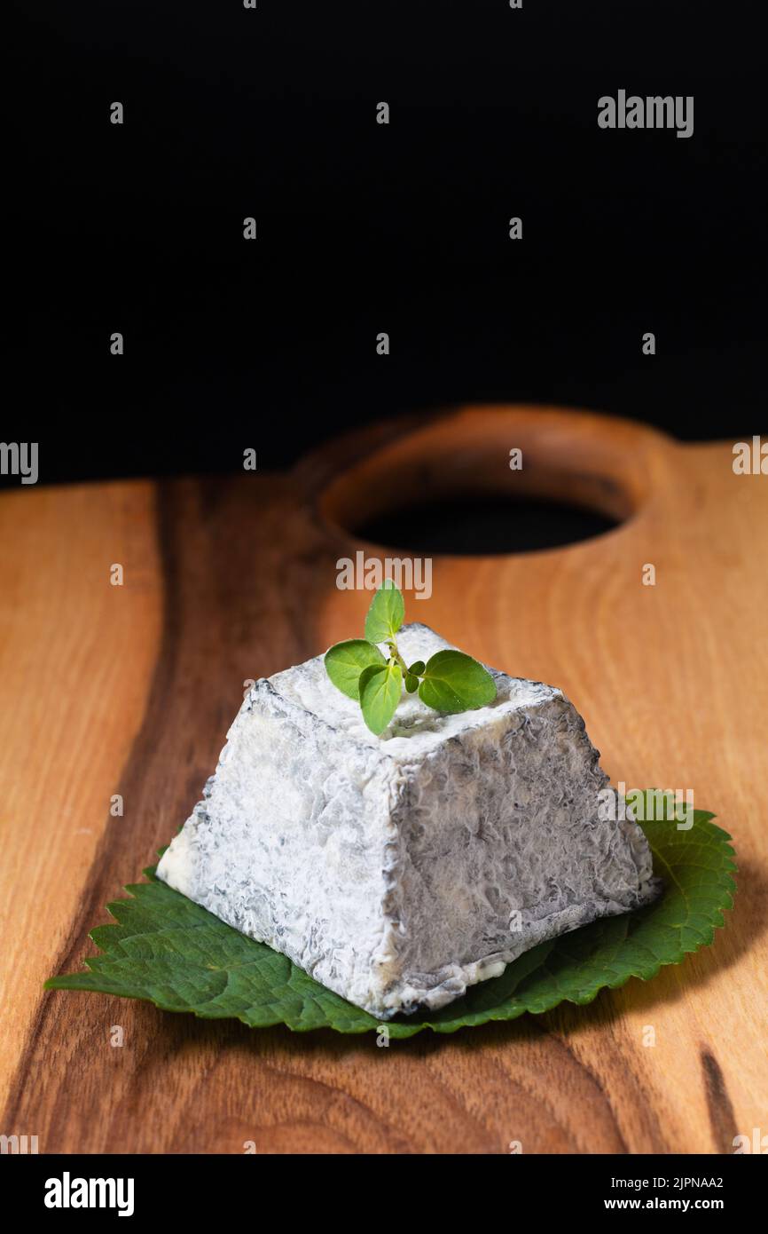Food concept organic Valencay cheese PDO pyramid shape on wooden board ...