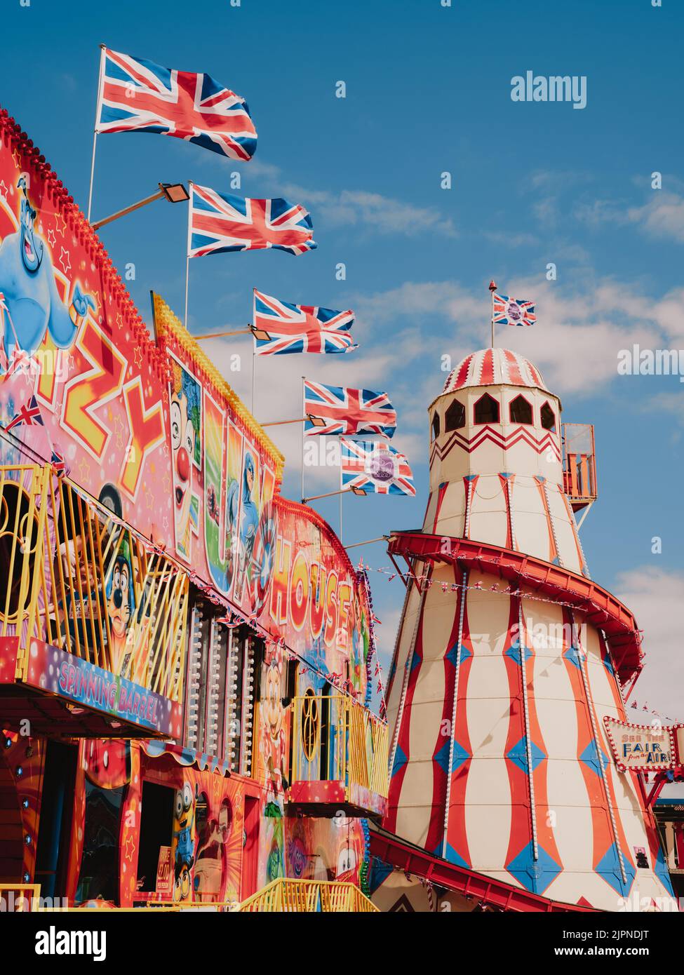 A colourful summer seaside funfair amusement park / pleasure beach with ...