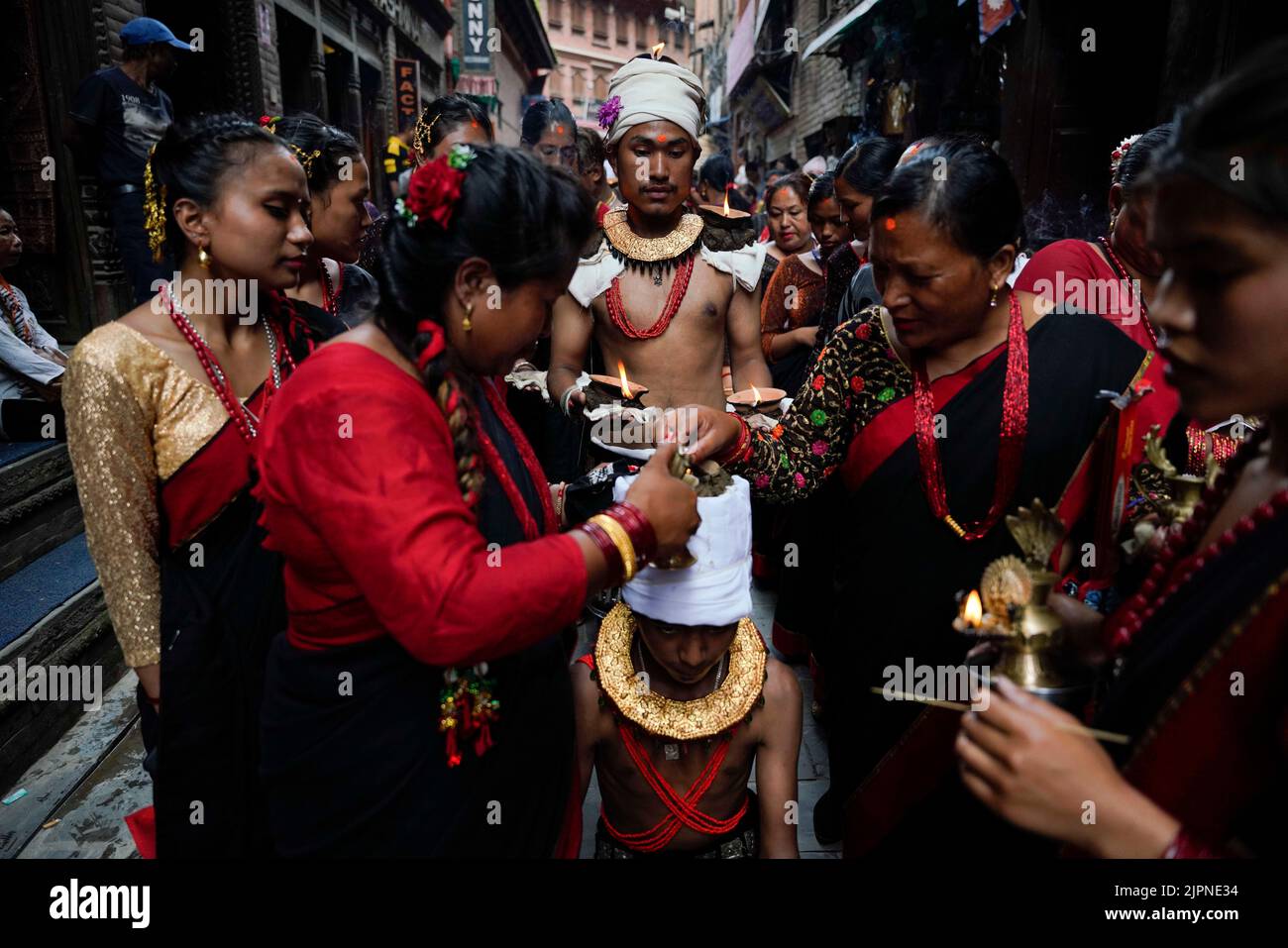 Young devotees with lit oil lamps on their heads and shoulders take ...