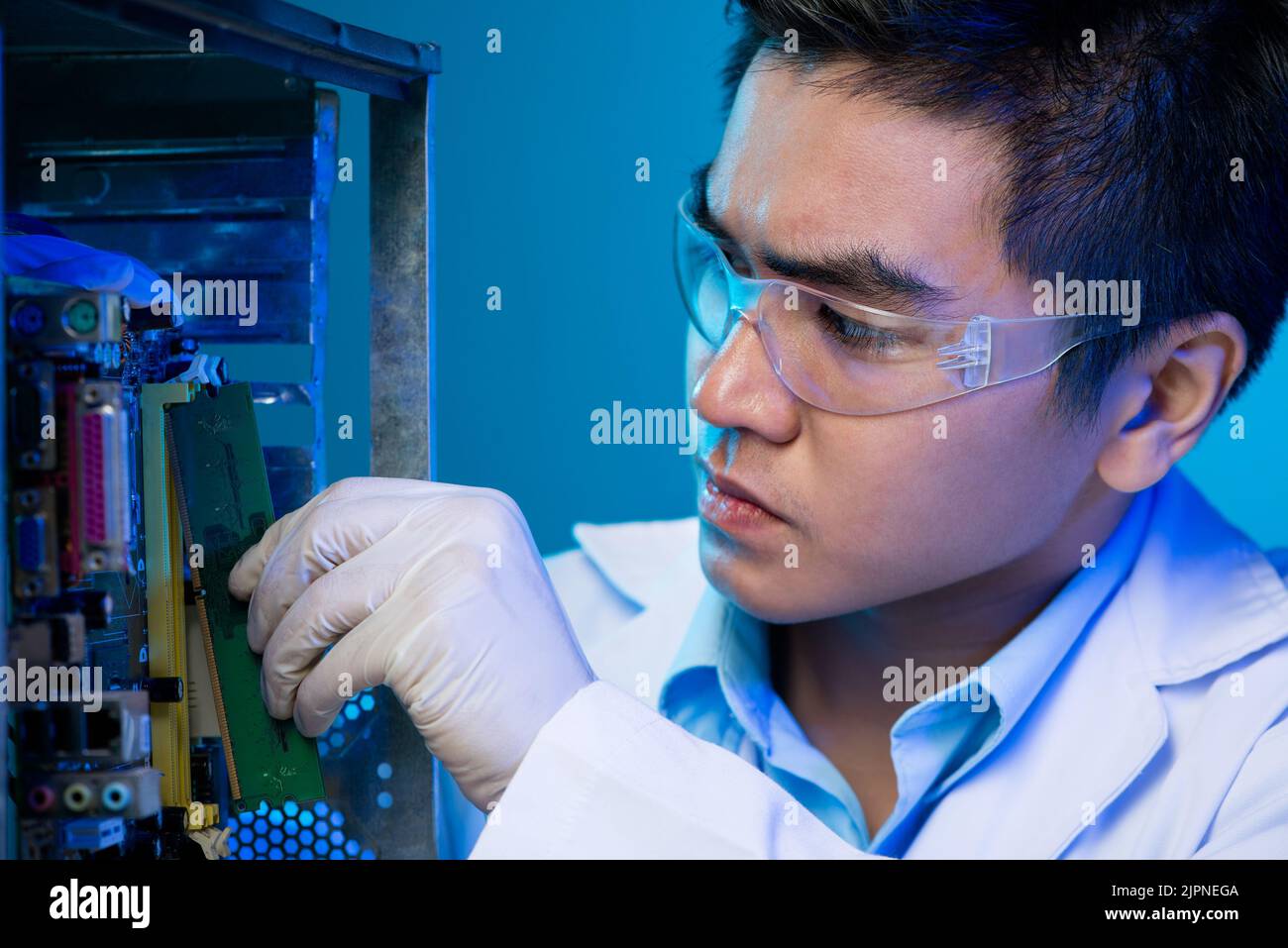 Computer technician putting board into hard drive Stock Photo - Alamy
