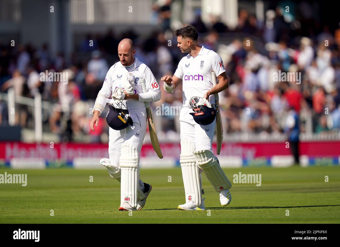 England's James Anderson (right) and Jack Leach walk off the pitch ...