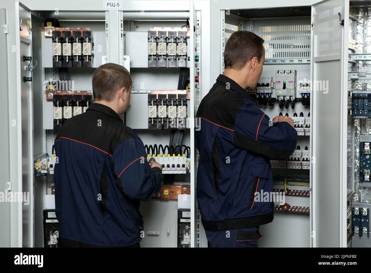 Electrician engineer work tester measuring voltage and current of power ...