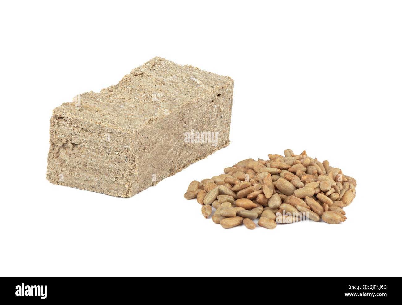 Sunflower halva and peeled sunflower seeds on a white background. Copy ...