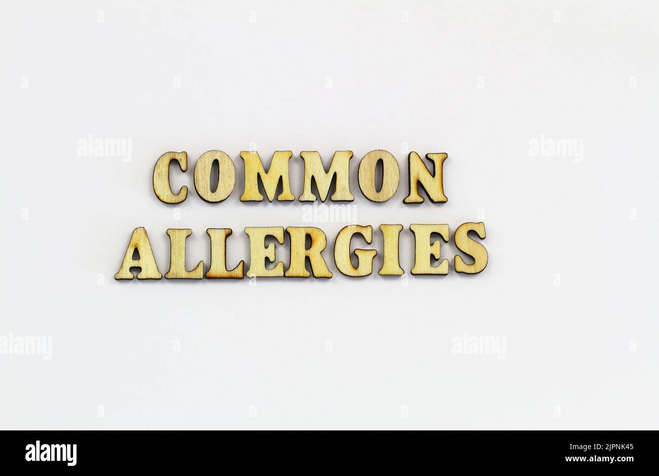 Common allergies written with wooden letters on white surface Stock ...