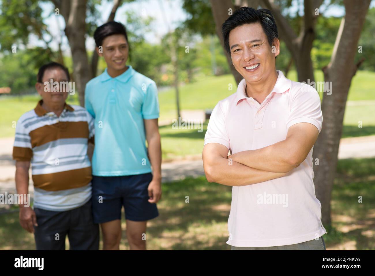 Happy middle-aged man and his father and son in the background Stock ...