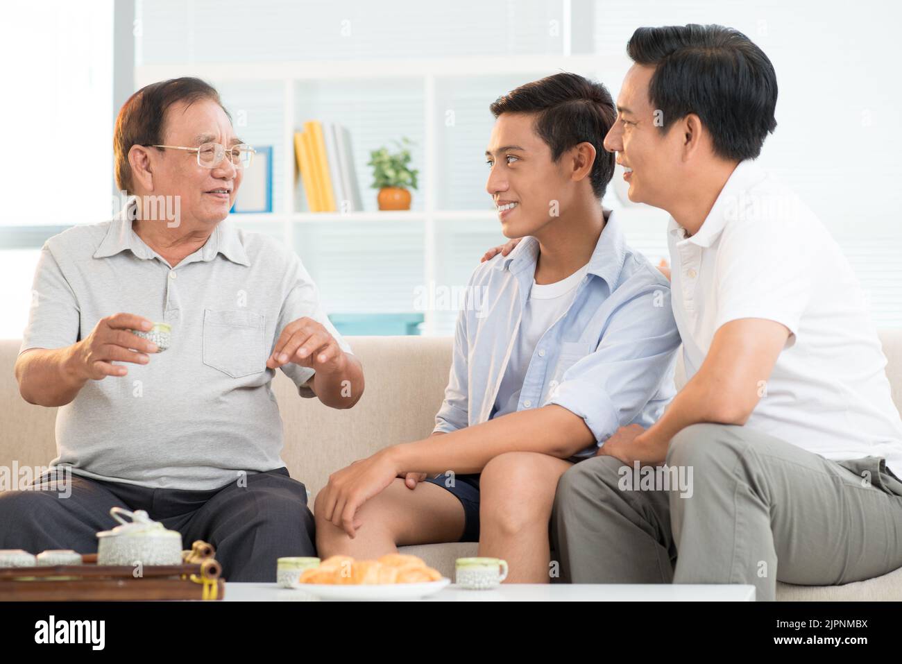grandfather telling story to his grandson Stock Photo - Alamy