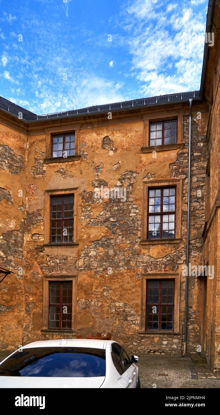 Surreal looking image of weathered masonry with chipped plaster between ...