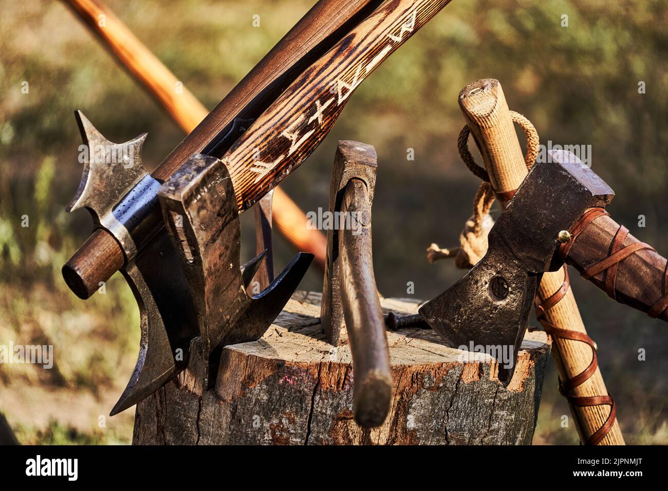 Hatchets and axes are stuck in a rustic wooden block Stock Photo - Alamy