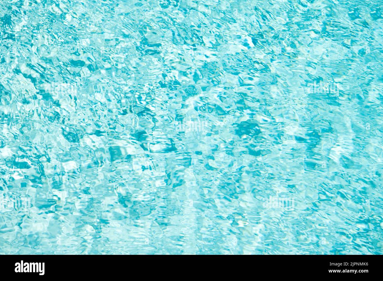 turquoise color backdrop of swimming pool water with ripples. concept ...