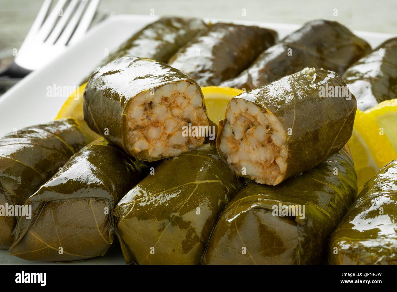 Whole and halved Greek dolmades on a plate close up Stock Photo - Alamy
