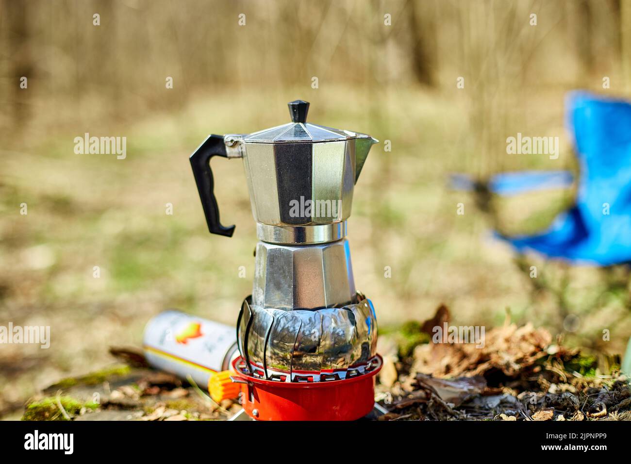 Making camping coffee from a geyser coffee maker on a gas burner ...