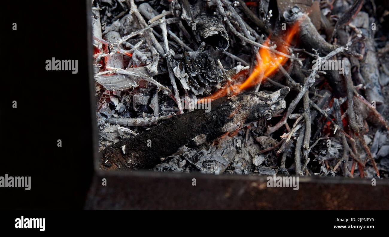 Burning red hot sparks fly from fire. Barbecue gril with glowing and ...