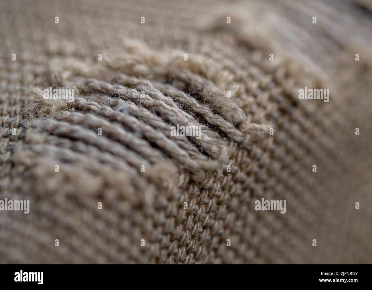 close-up to the tear of the old cloth bag Stock Photo - Alamy