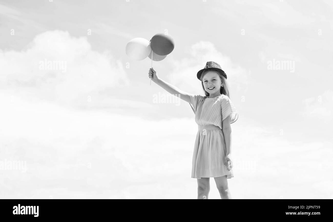happy childhood. cute child on sky background with balloons. spring ...