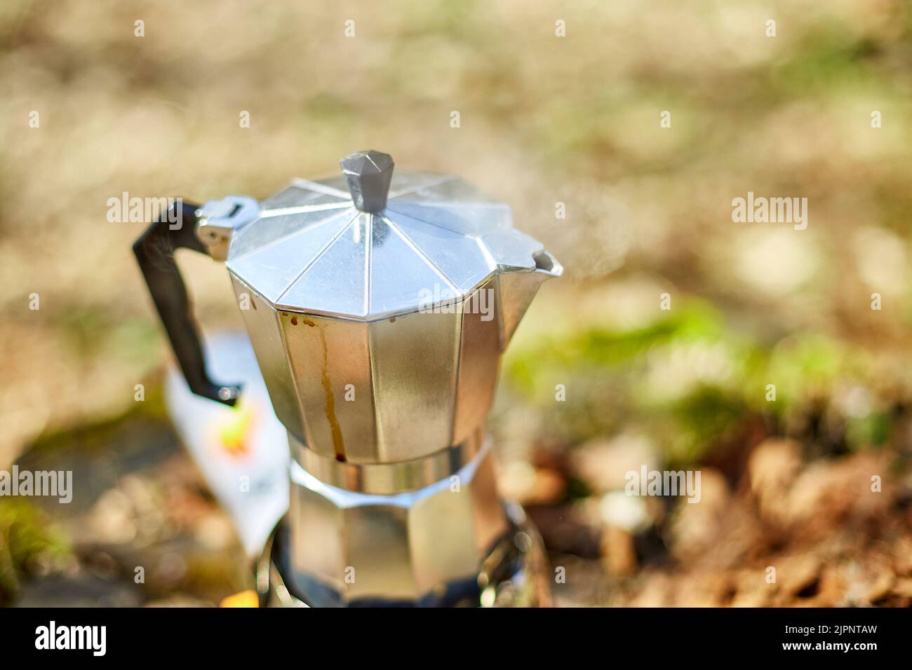 Making camping coffee from a geyser coffee maker on a gas burner ...