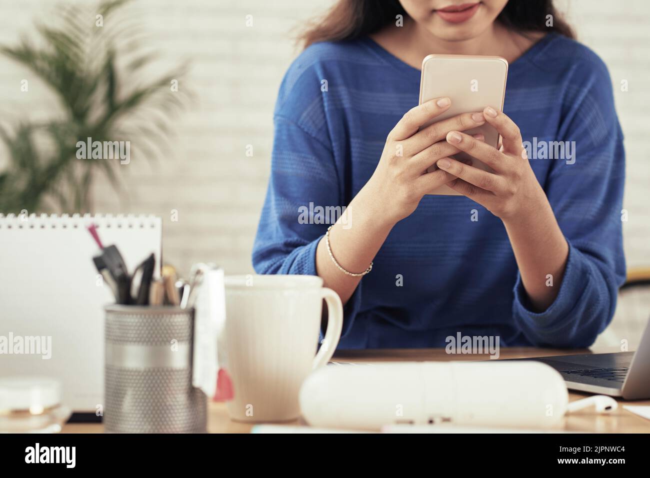Cropped image of young woman using application on her phone Stock Photo ...