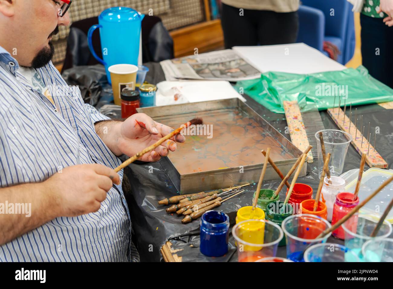 Artist Tugay Yalcin teaches beginners the art of paper marbling, a ...
