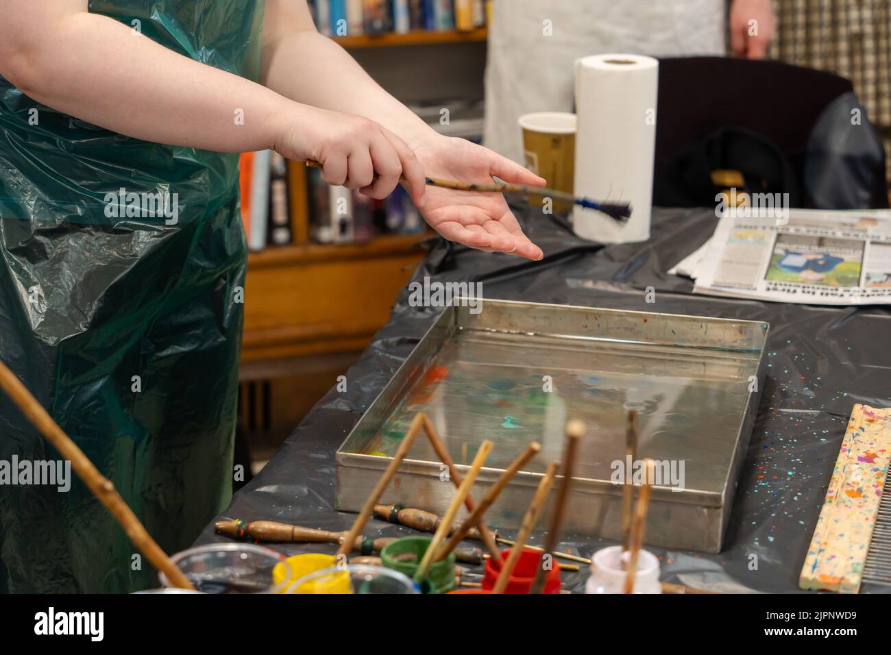 Artist Tugay Yalcin teaches beginners the art of paper marbling, a ...