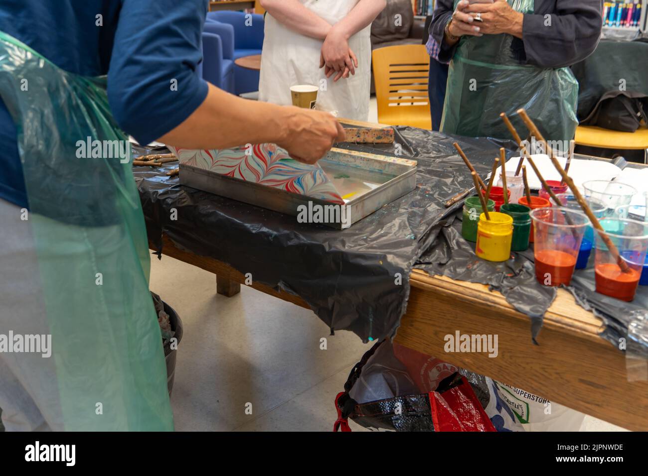 Artist Tugay Yalcin teaches beginners the art of paper marbling, a ...
