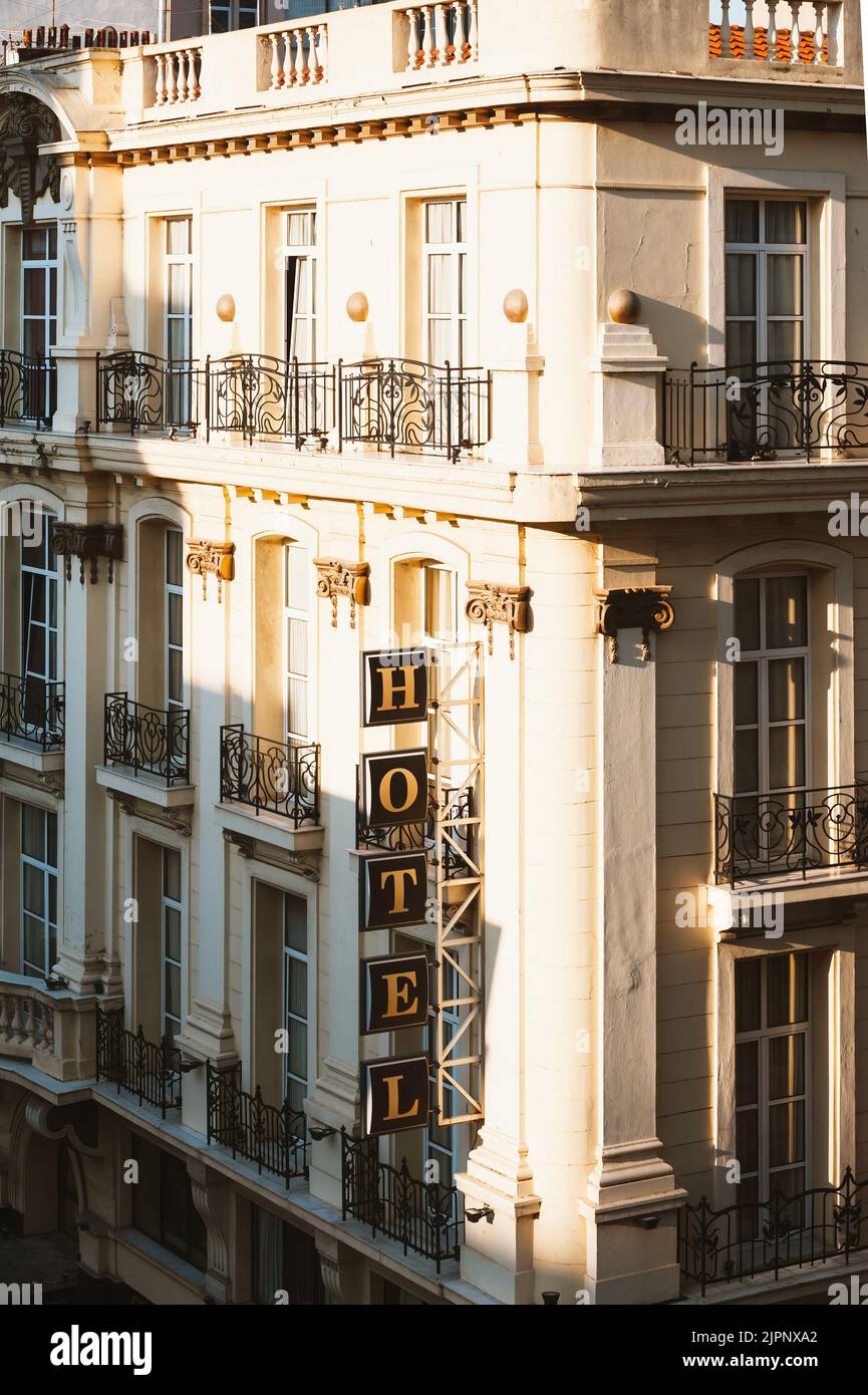 Wide view of hotel vertical sign on the facade of luxury five star ...