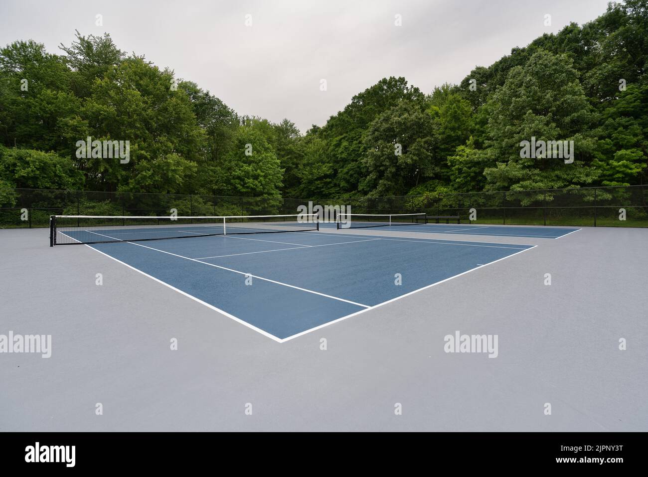 New blue tennis court with white lines and gray out of bounds Stock ...