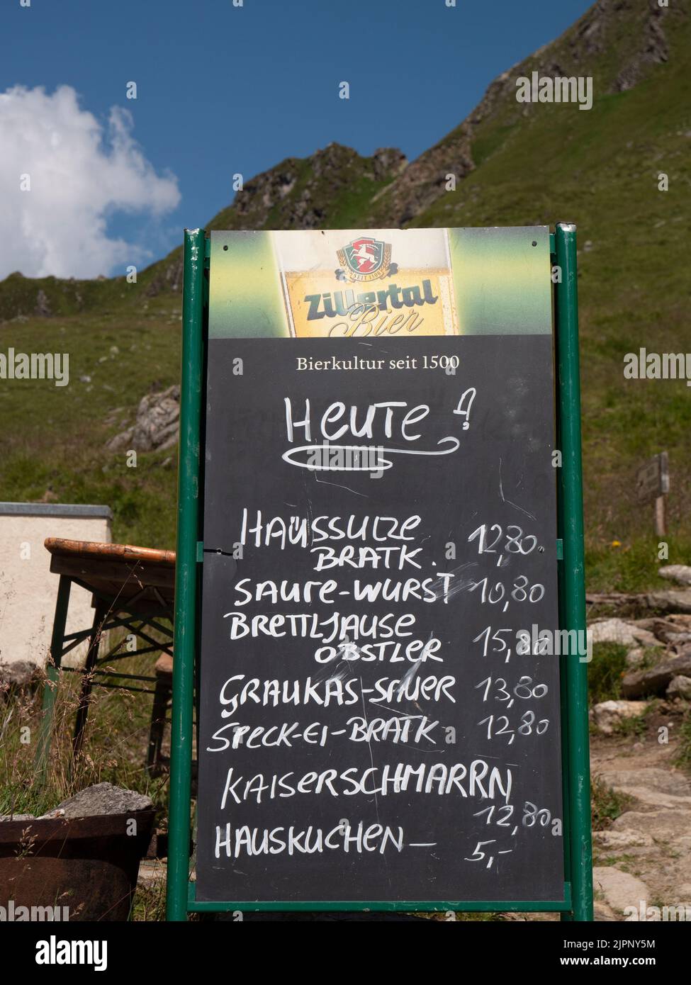 The image is of menu signboard at the Karl von Edel Hut mountain refuge ...