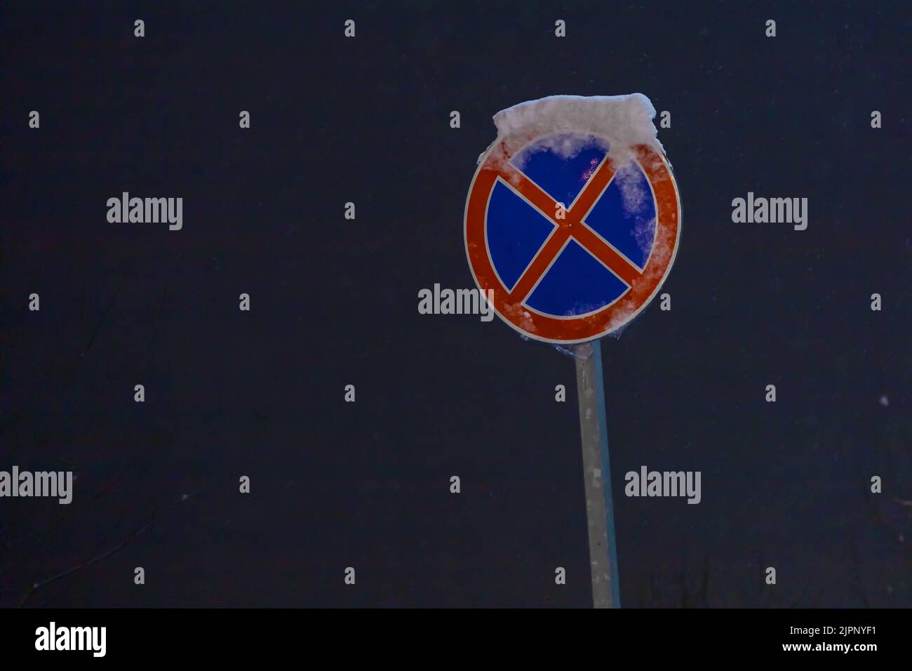 Road sign covered with snow at night Stock Photo - Alamy