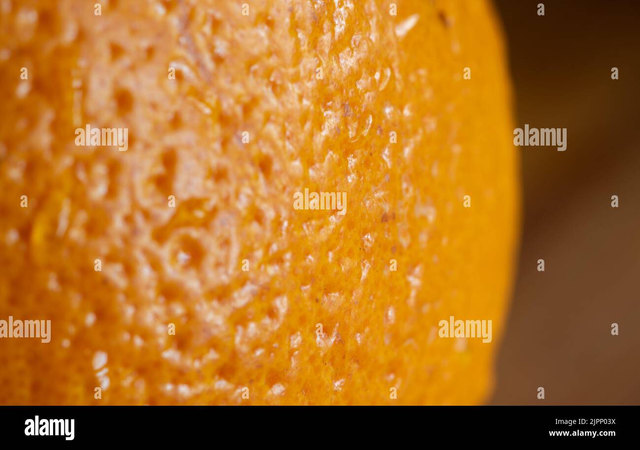 Orange in close-up. Structure of an orange peel on a macro scale. Juicy ...
